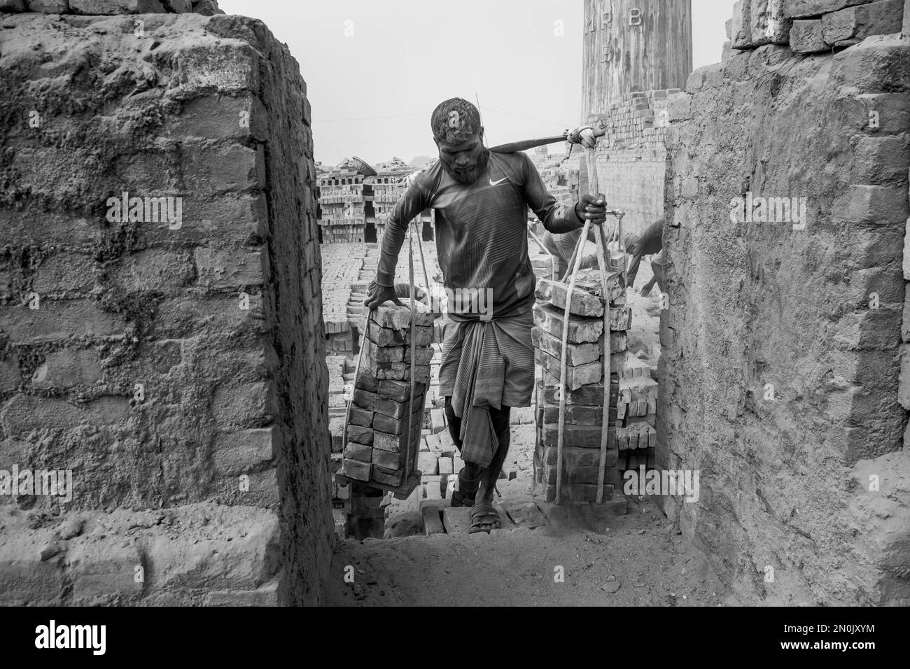 People are working hard in the brick field. This image was taken from ...
