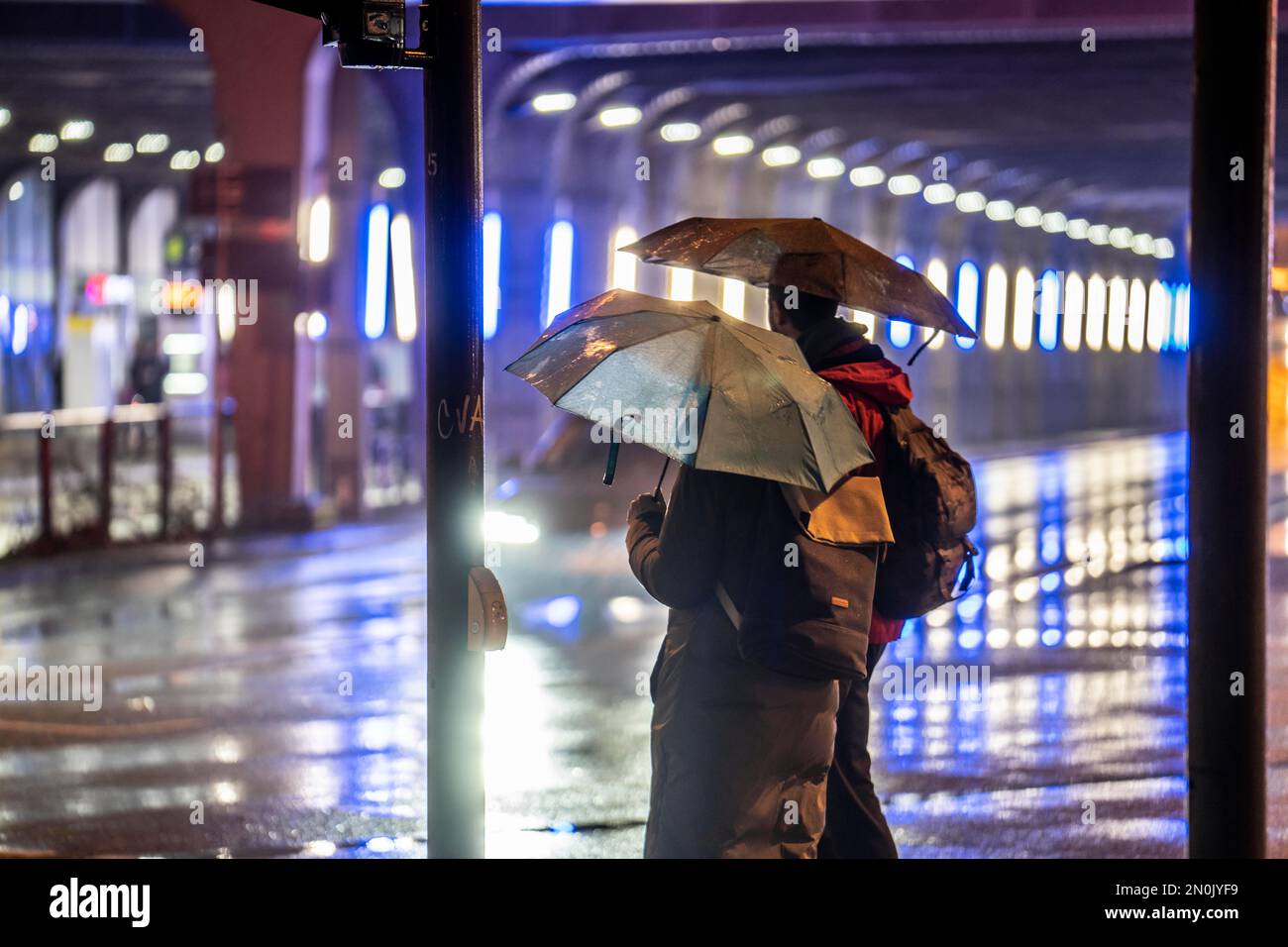 Illuminated subway at the main station, passers-by at a pedestrian ...