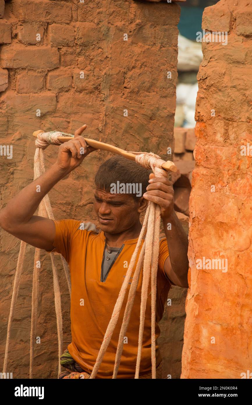 People are working hard in the brick field. This image was taken from ...