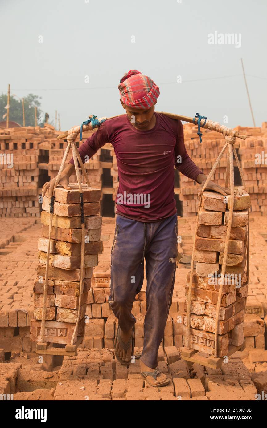 People are working hard in the brick field. This image was taken from ...