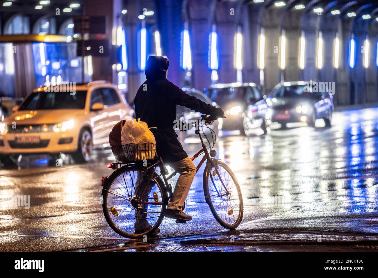 Street at the main station, cyclist, rainy weather, city centre, in the ...