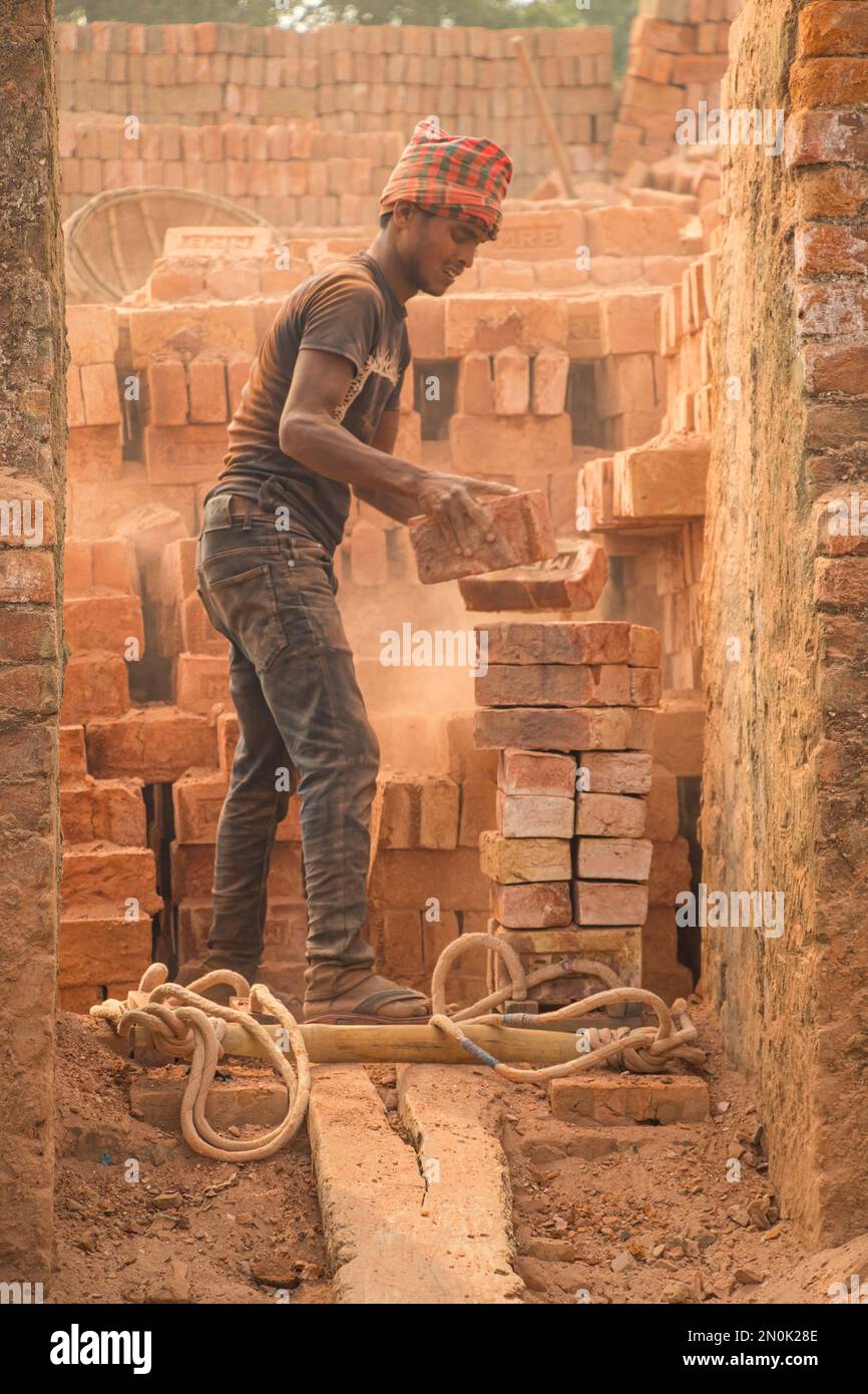 People are working hard in the brick field. This image was taken from ...