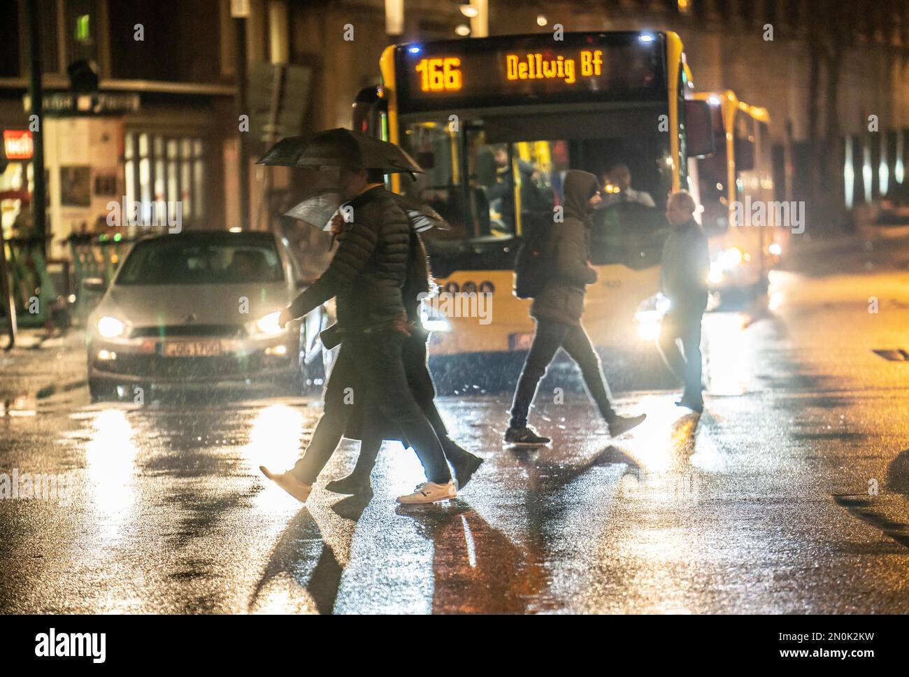 Passers-by at a pedestrian crossing, at the main station, rainy weather ...