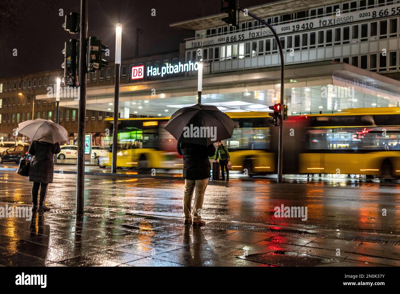 Passers-by at a pedestrian crossing, at the main station, rainy weather ...