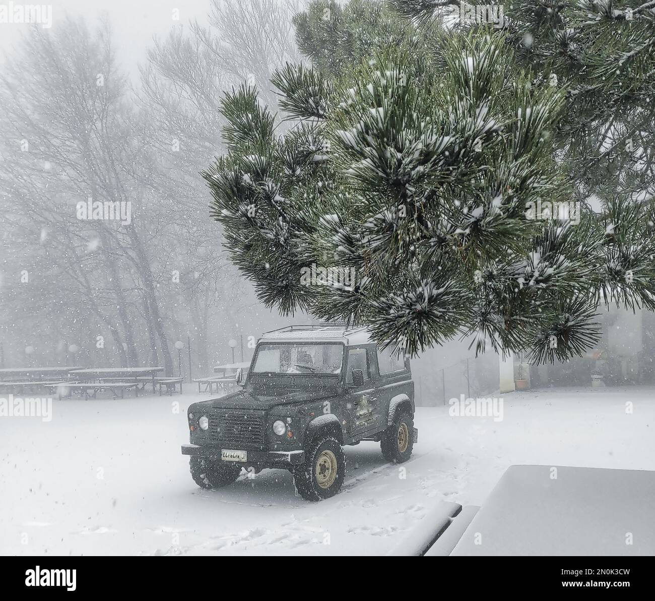 A jeep driving while it's snowing through a forest, Blizzard in a ...