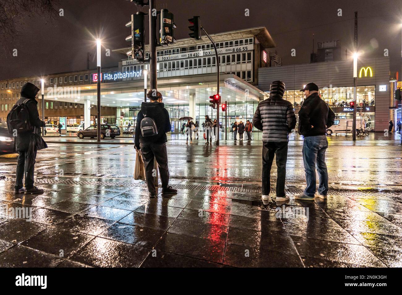 Passers-by at a pedestrian crossing, at the main station, rainy weather ...