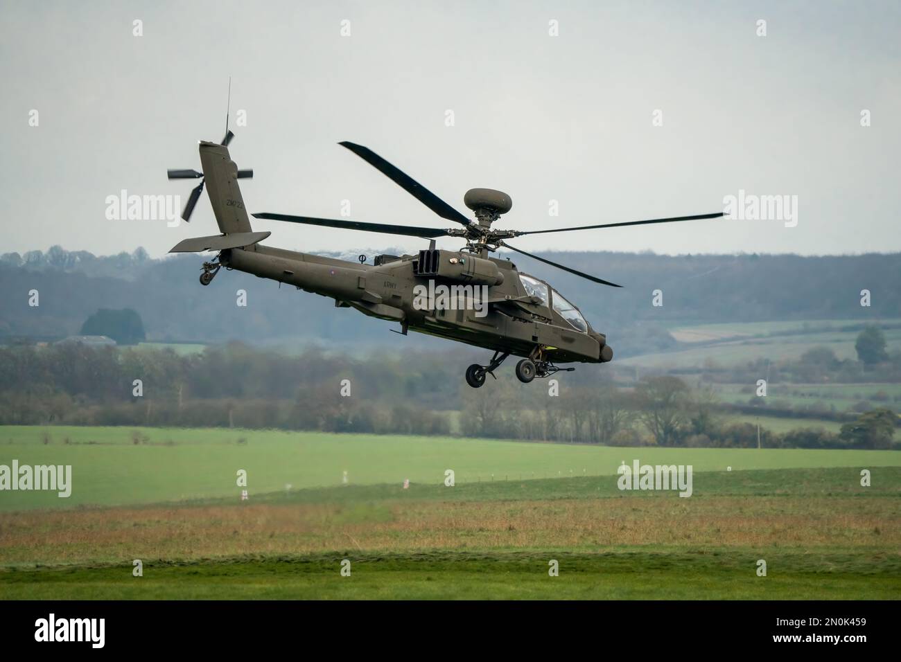 A military helicopter landing in a field Stock Photo - Alamy