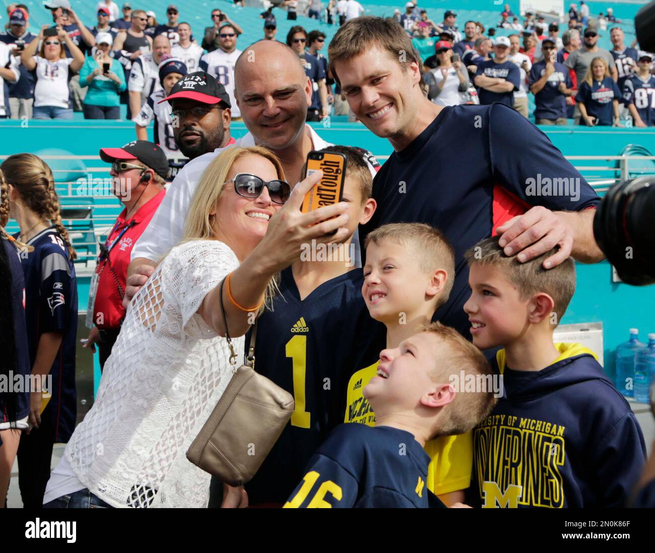 New England Patriots quarterback Tom Brady talks a selfie with Jason ...