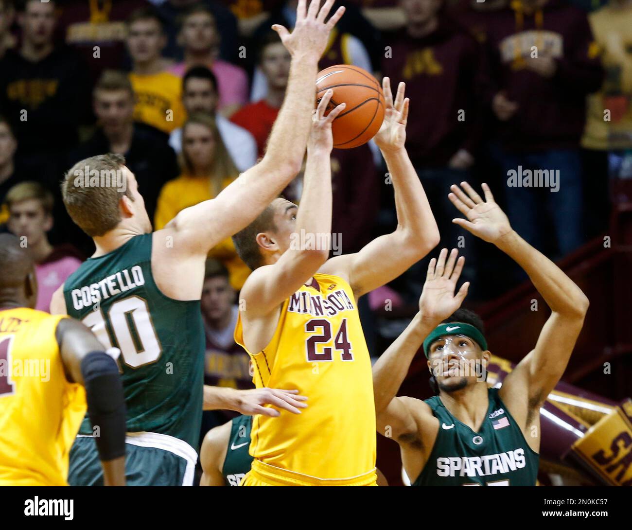 Minnesota’s Joey King, center, attempts a shot between Michigan State’s ...