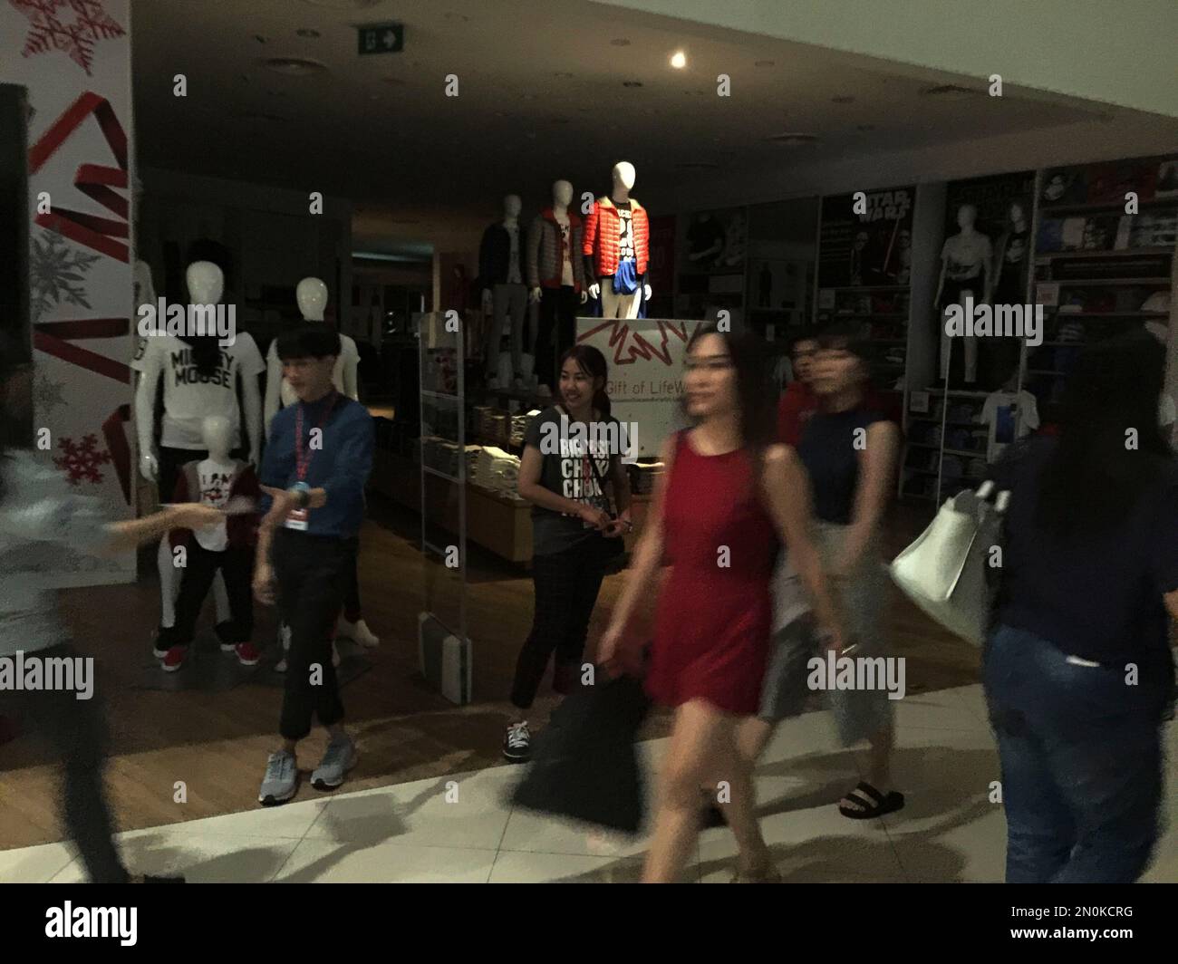 Shoppers walk in the dark after an apparent power outage at Mega Bangna ...