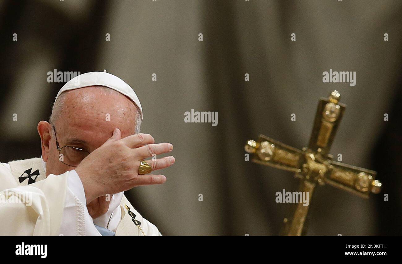 Pope Francis makes the sign of the cross as he celebrates a New Year's ...