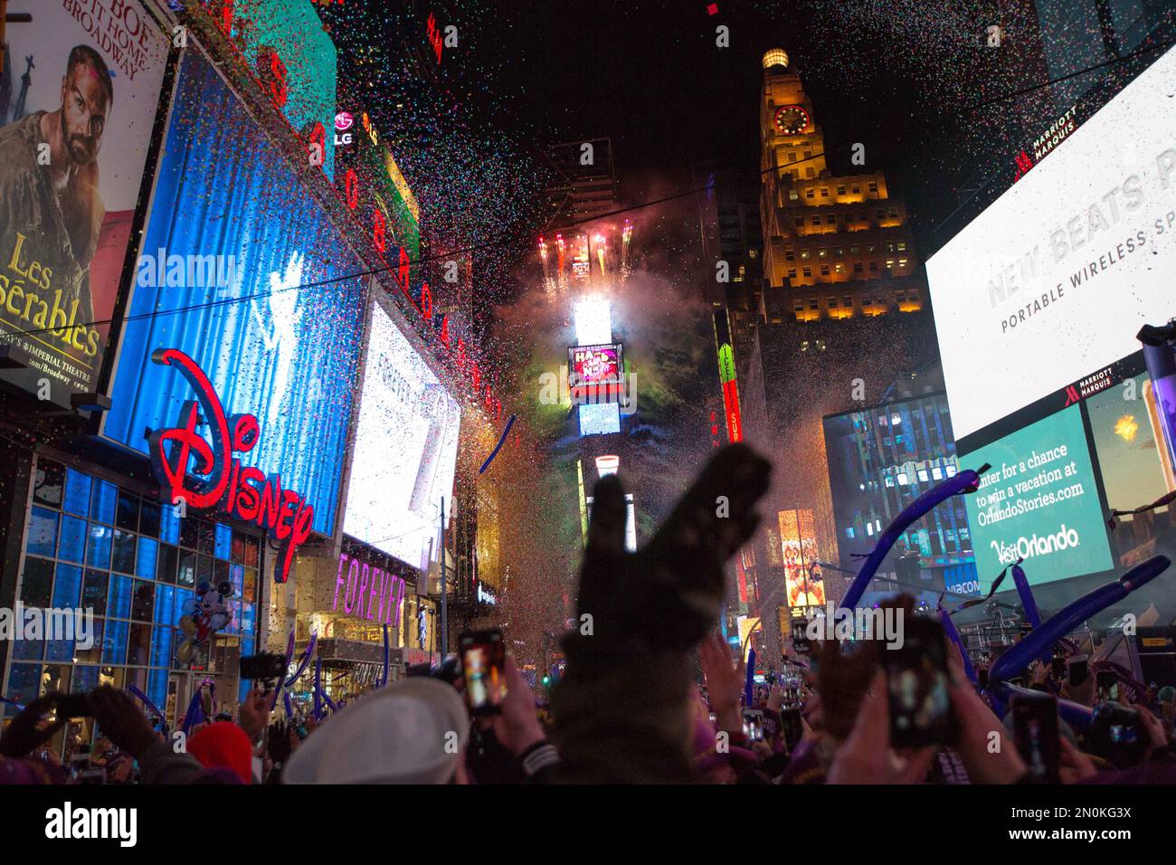 Fireworks are launched from a building as the ball drops during the ...
