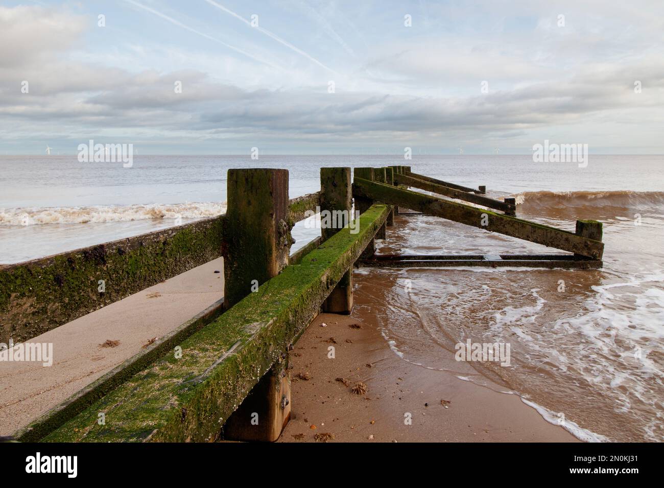 Wooden sea breakers on the seafront beach in Segness in early February ...