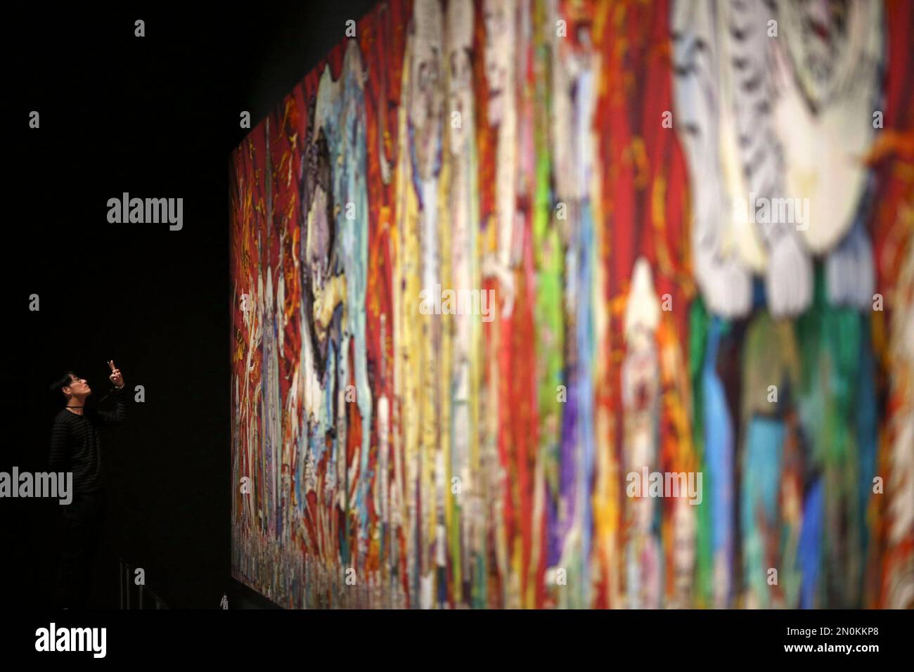 In this Dec. 29, 2015 photo, a visitor takes photos of Japanese artist ...