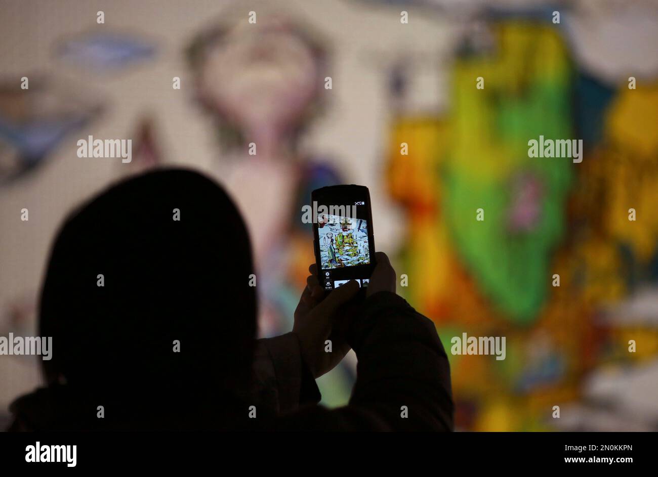 In this Dec. 29, 2015 photo, a visitor takes photos of Japanese artist ...