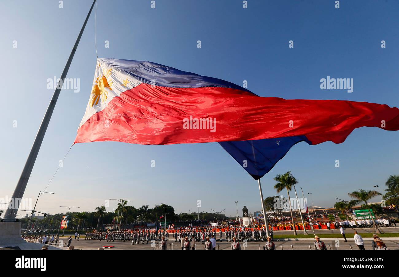 A giant Philippine flag is raised during flag-raising ceremony to ...