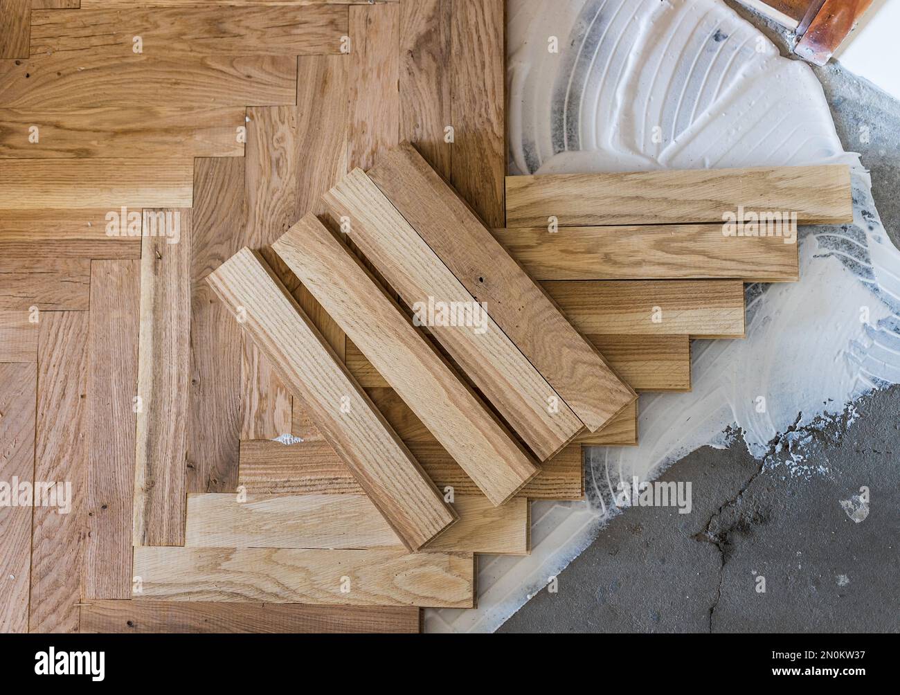Top view of parquet boards installing in herringbone arrangement on ...