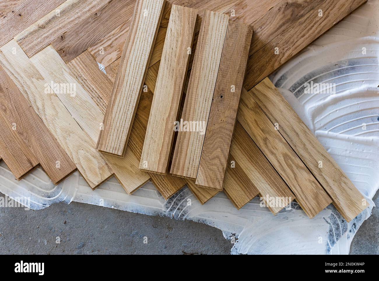 Top view of parquet boards installing in herringbone arrangement on ...