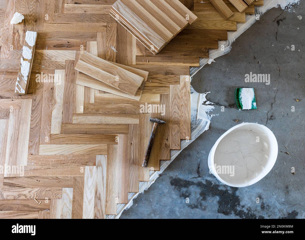 Top view of parquet boards installing in herringbone arrangement with ...