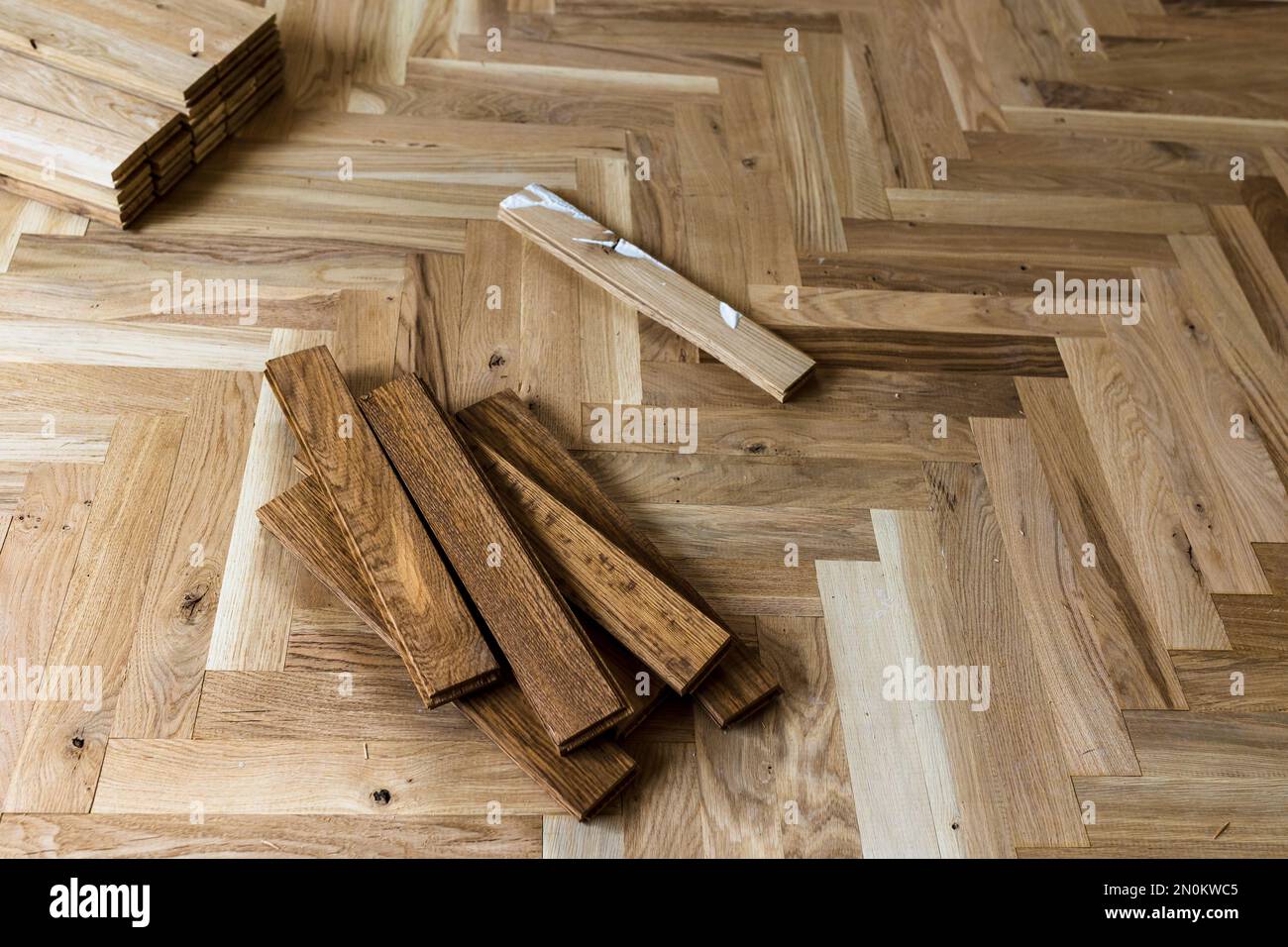 Top view of parquet boards installing in herringbone arrangement, home ...