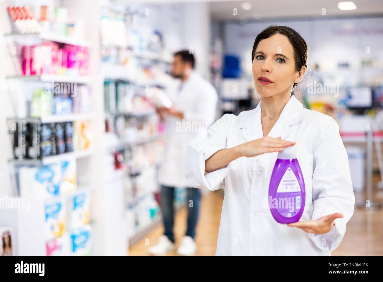 Portrait of friendly laughing pharmacist working in farmacy Stock Photo ...