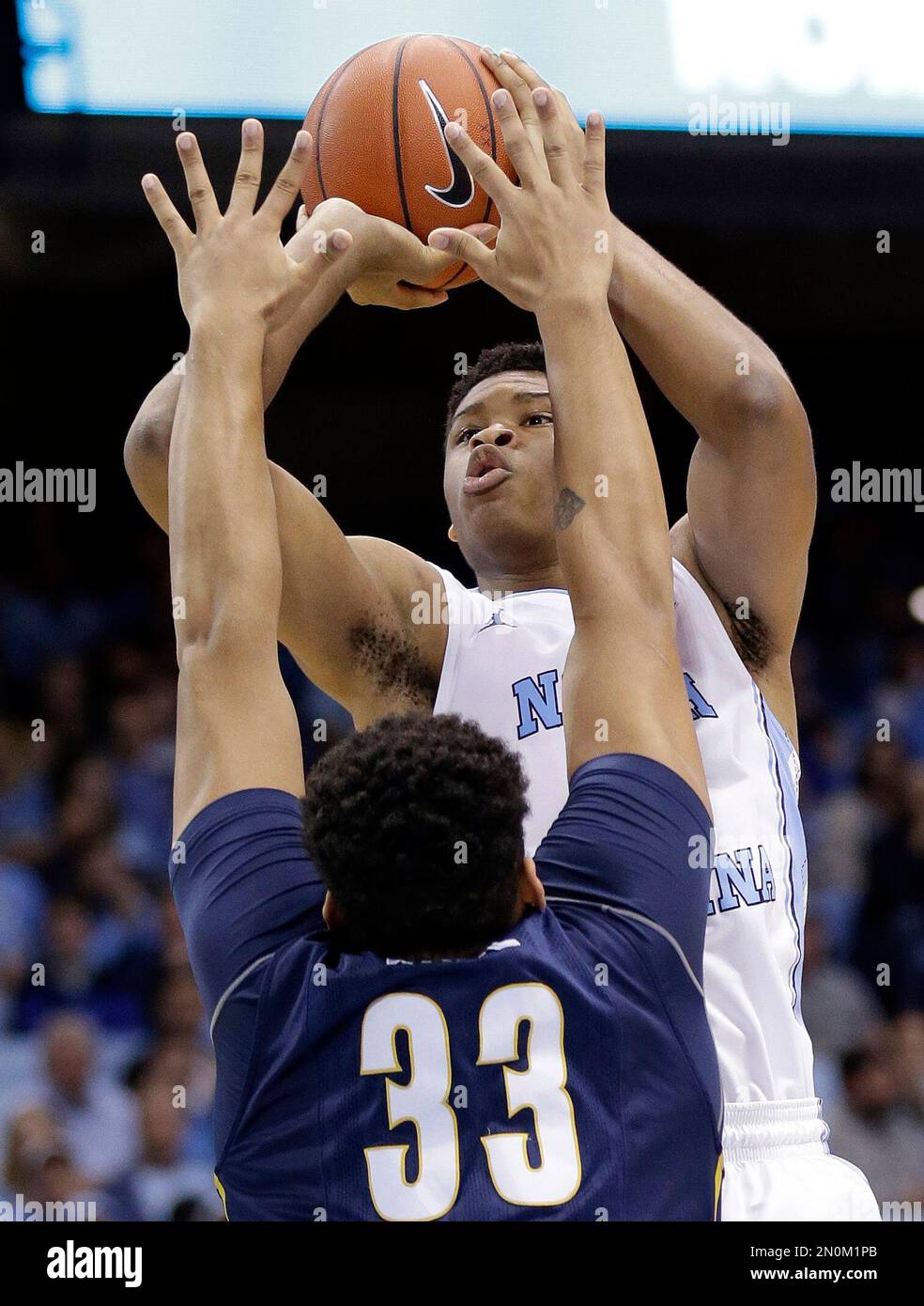 North Carolina's Isaiah Hicks shoots as UNC Greensboro's RJ White (33 ...