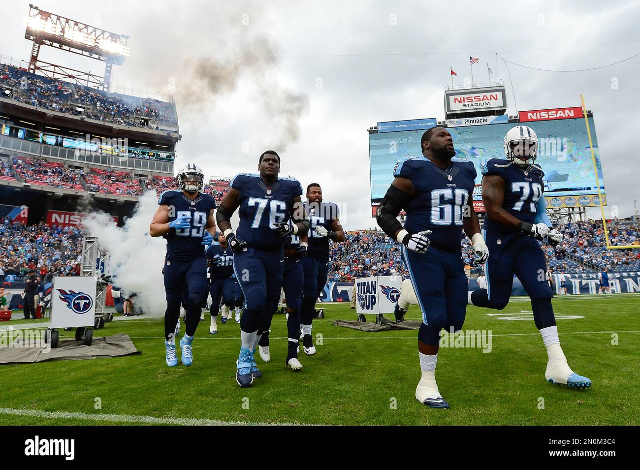 Tennessee Titans players enter the field before an NFL football game ...