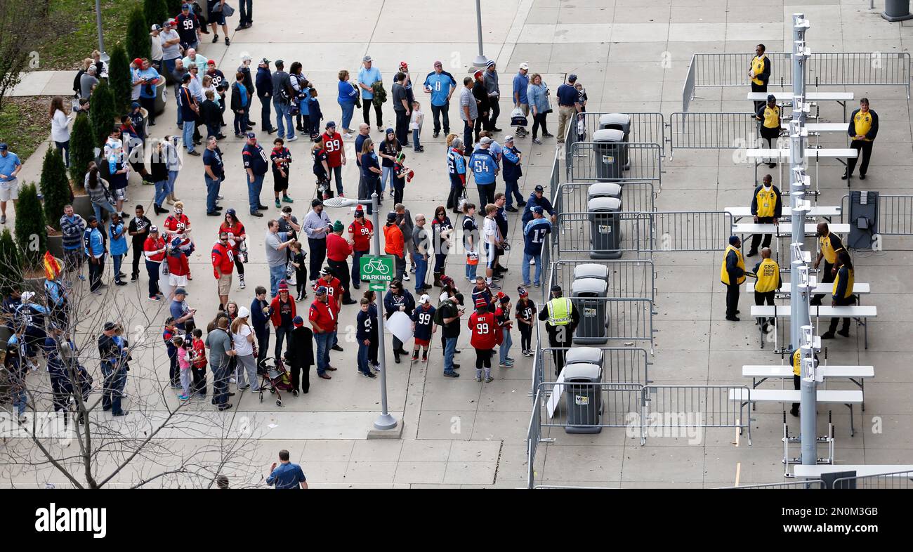 Fans line up to enter Nissan Stadium through a security entrance before ...