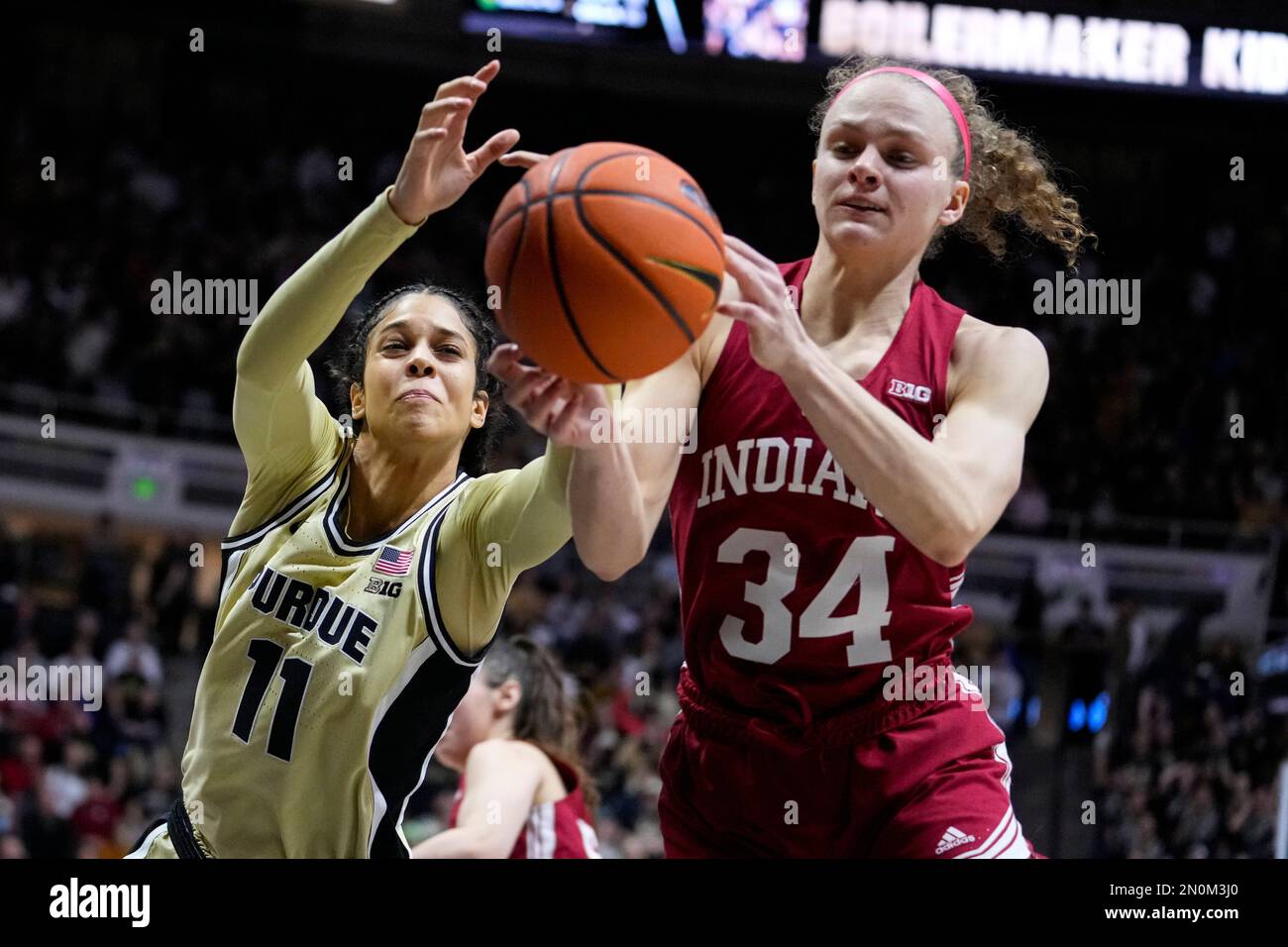 Indiana guard Grace Berger (34) grabs rebound in front of Purdue guard ...