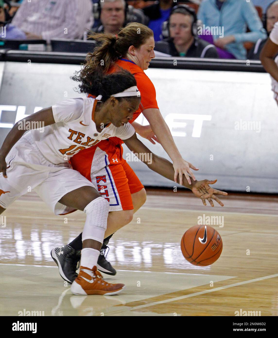 Texas guard Lashann Higgs, front, fights for the ball with Sam Houston ...