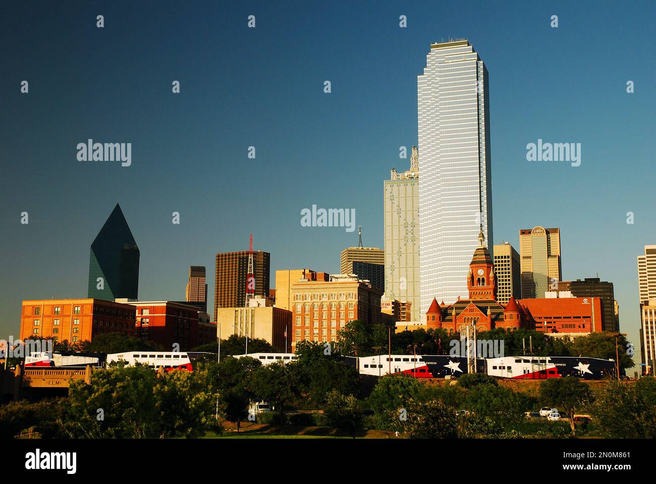 The Trinity Express train pulls into Dallas in front of the business ...