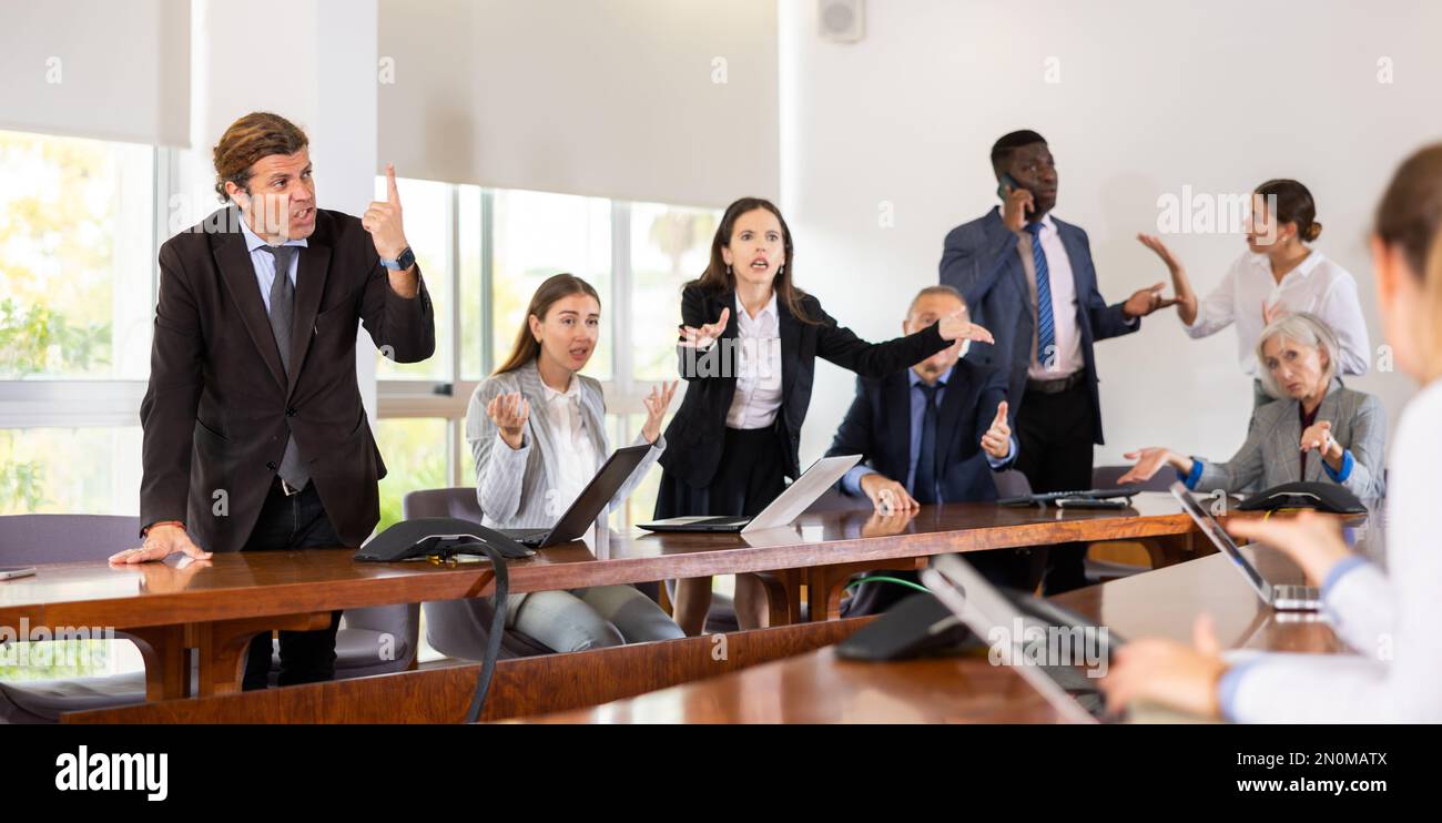 Managers expressing dissatisfaction with teamwork of colleagues at ...