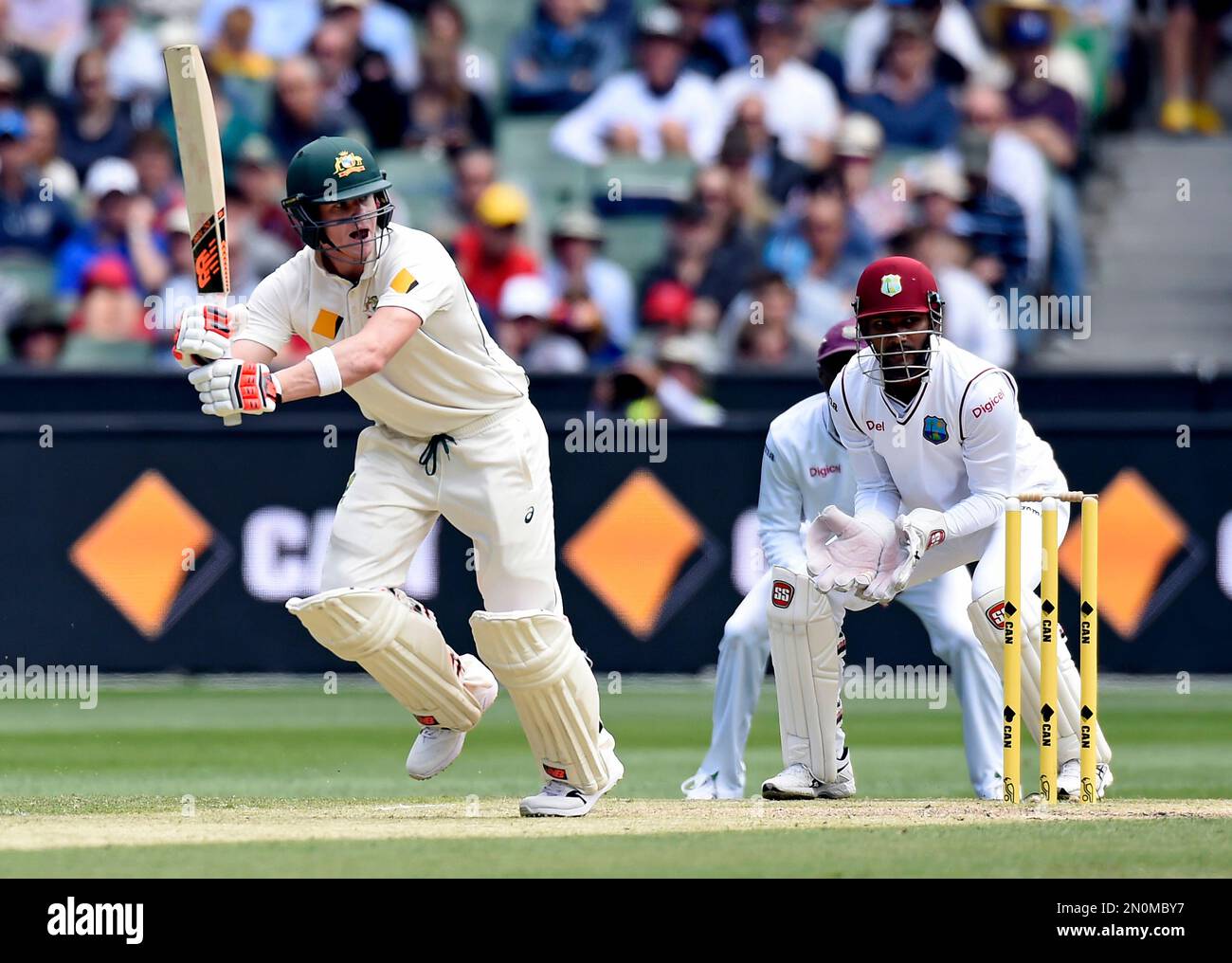 Australia's Steve Smith, left, bats as West Indies keeper Denesh Ramdin ...