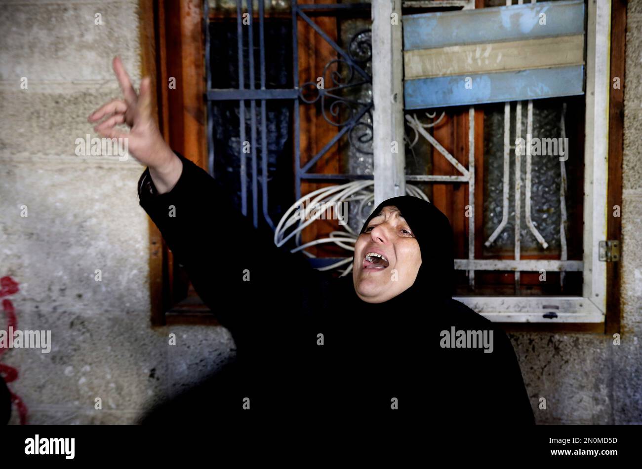 A Palestinian woman chants Islamic slogans during the funeral of Hani ...
