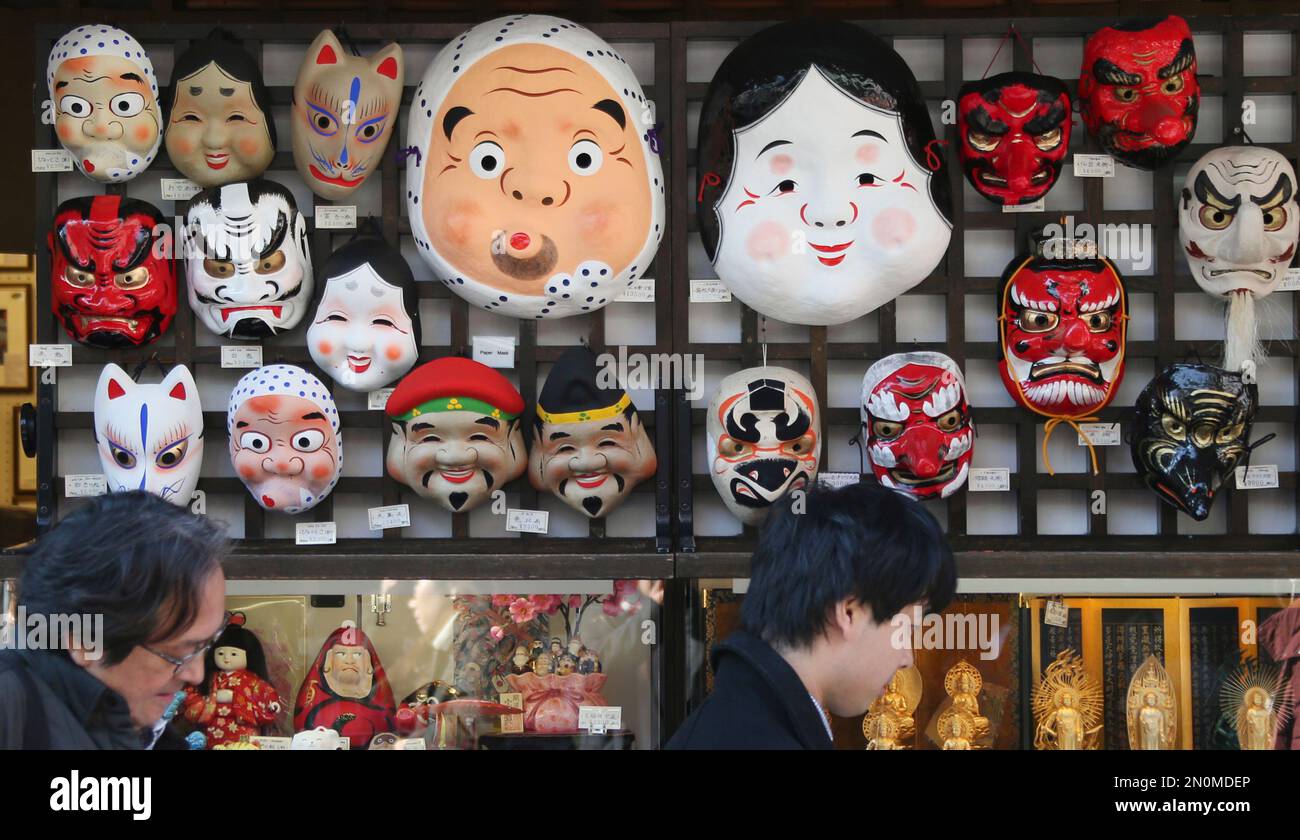 Year-end visitors walk through a Japanese traditional mask shop at ...