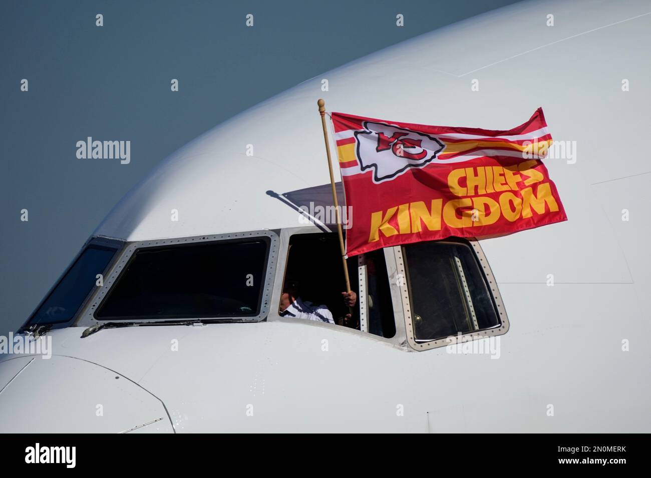 A Kansas City Chiefs flag flies from the team plane as they arrive ...