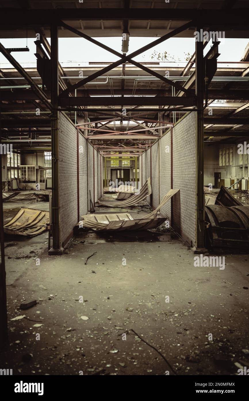 An interior of an old and abandoned factory with dirt and debris all ...