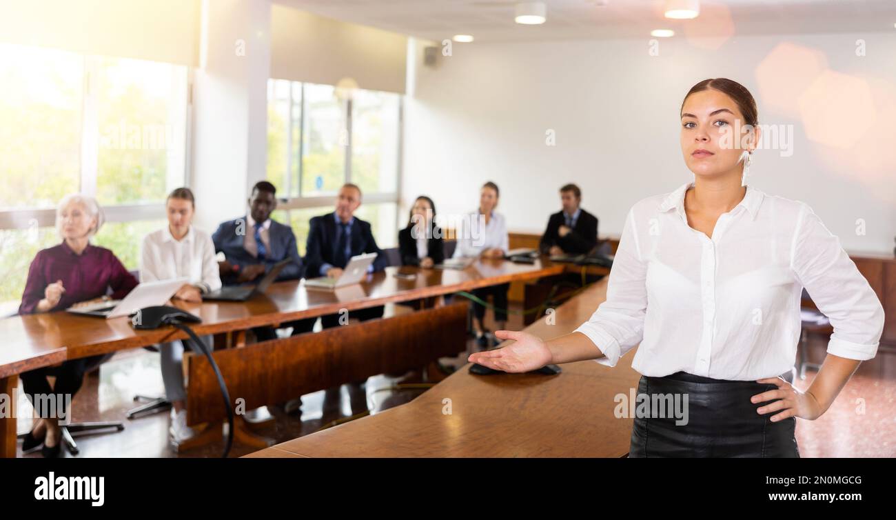 Millennial white businesswoman posing with inviting hand gesture Stock ...
