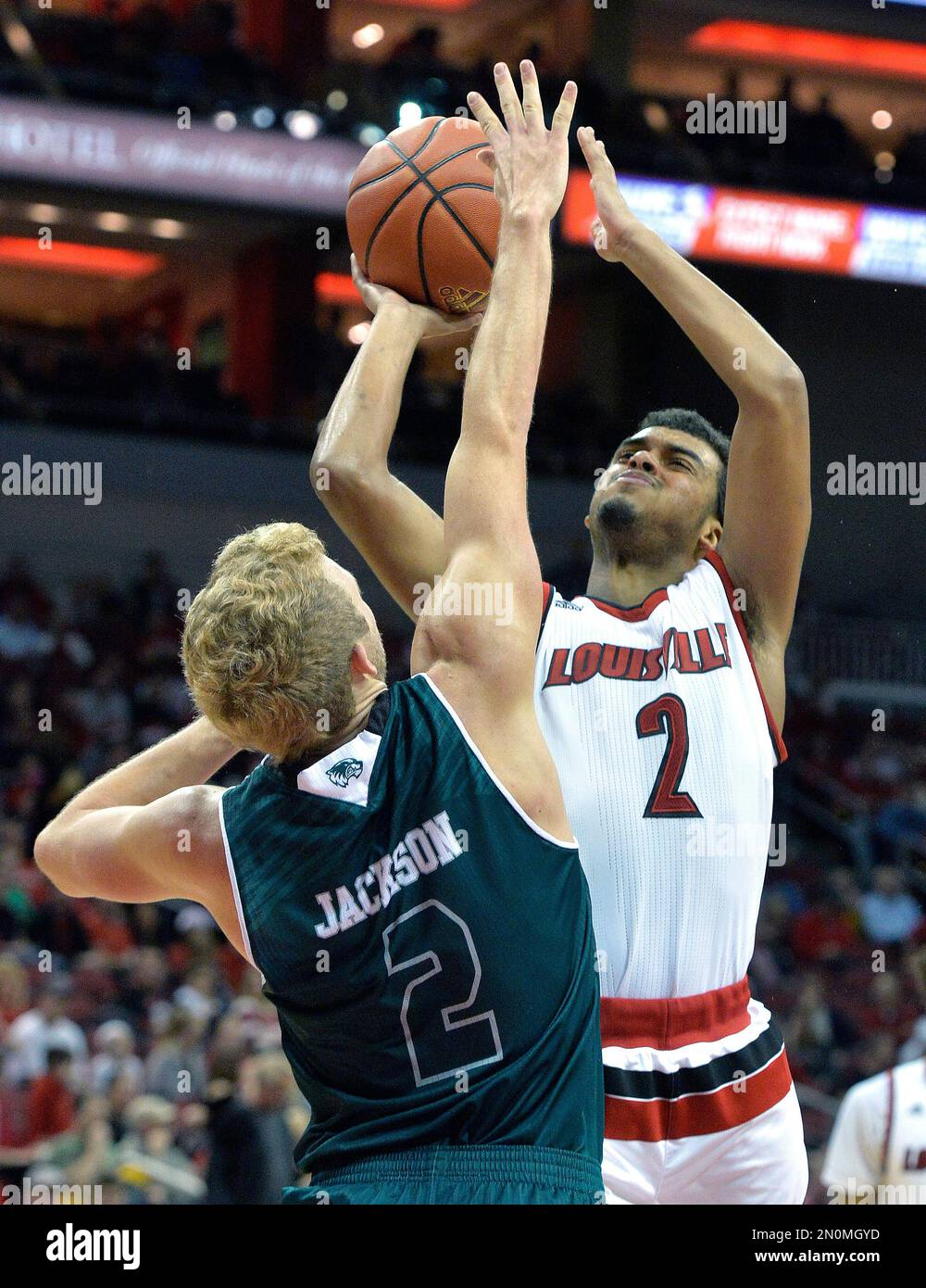 Louisville's Quentin Snider (2) shoots over Utah Valley's Jaden Jackson ...