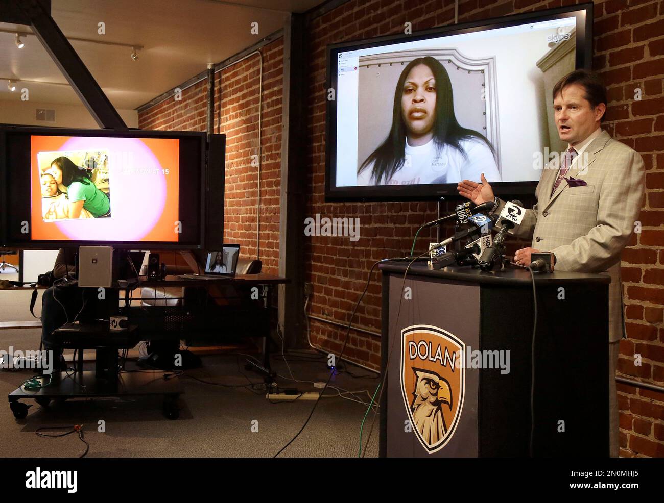 Attorney Christopher Dolan, right, speaks next to Nailah Winkfield ...