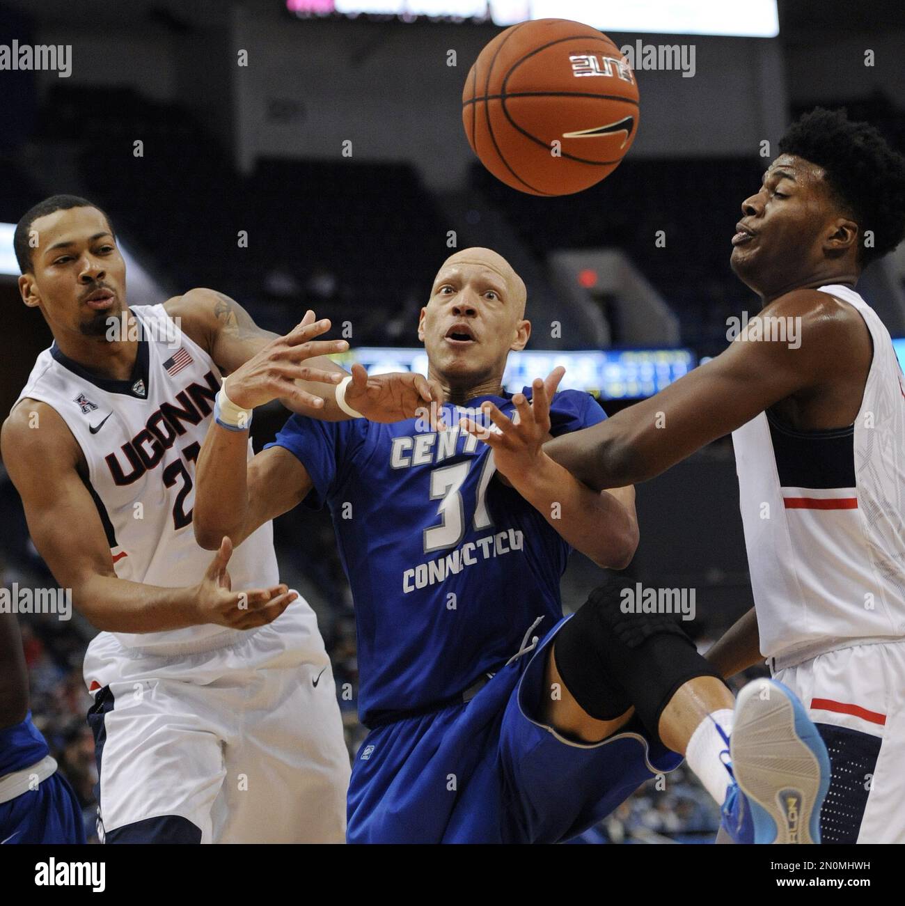 Central Connecticut State’s Brandon Peel, center, bobbles a rebound ...
