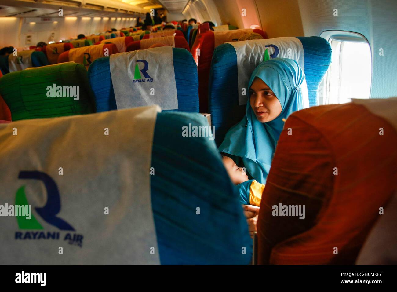 In this Dec. 22, 2015, photo, a Muslim woman passenger comforts her ...