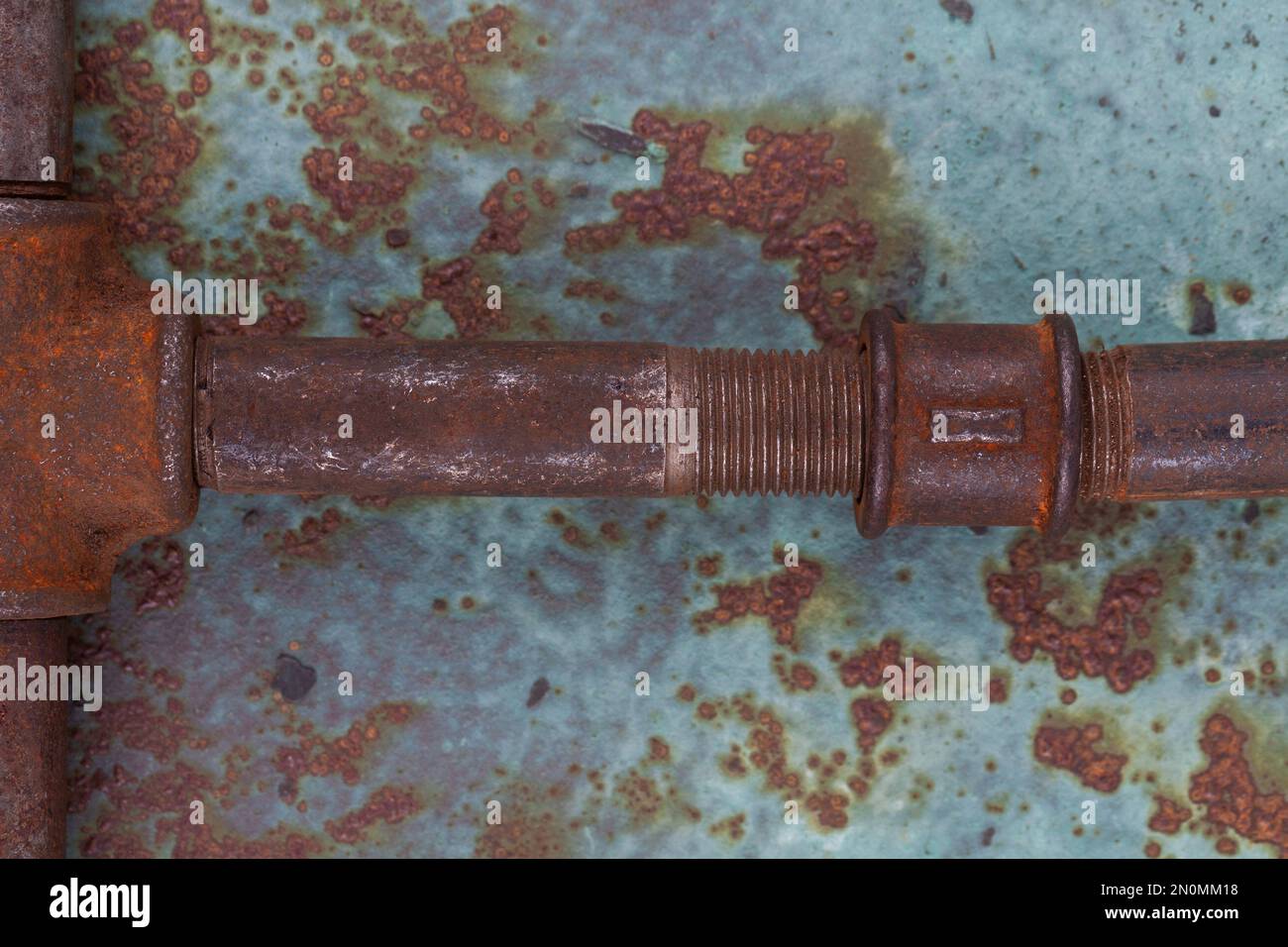 Old rusty valve pipes on rusty metal wall background Stock Photo - Alamy