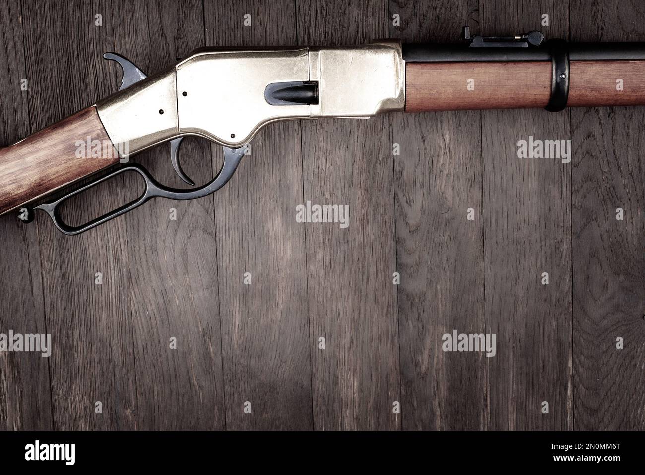 Old west gun - lever-action repeating rifle on wooden table Stock Photo ...