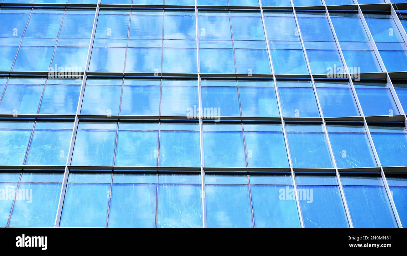 Modern office building with glass facade on a clear sky background ...