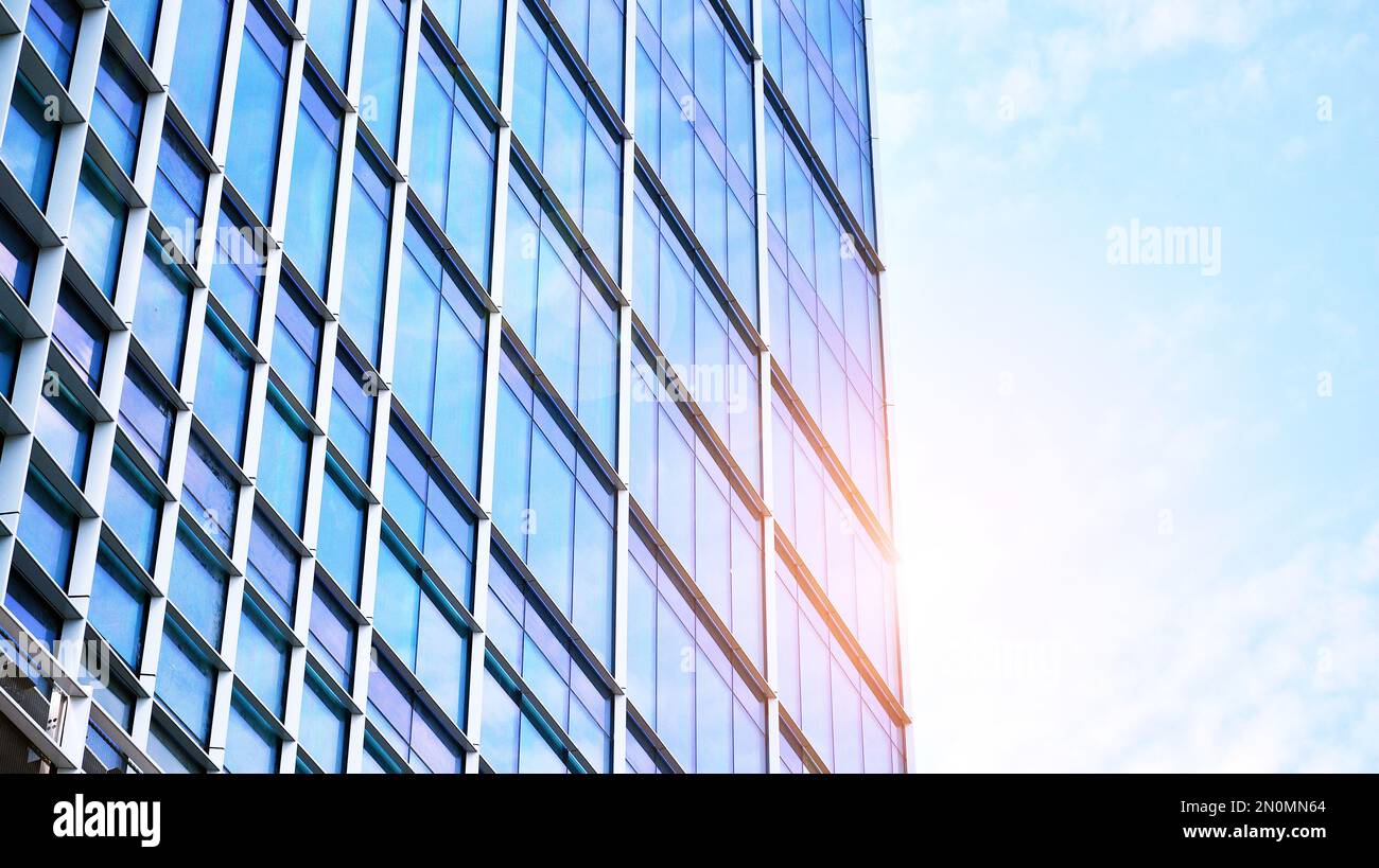 Modern office building with glass facade on a clear sky background ...