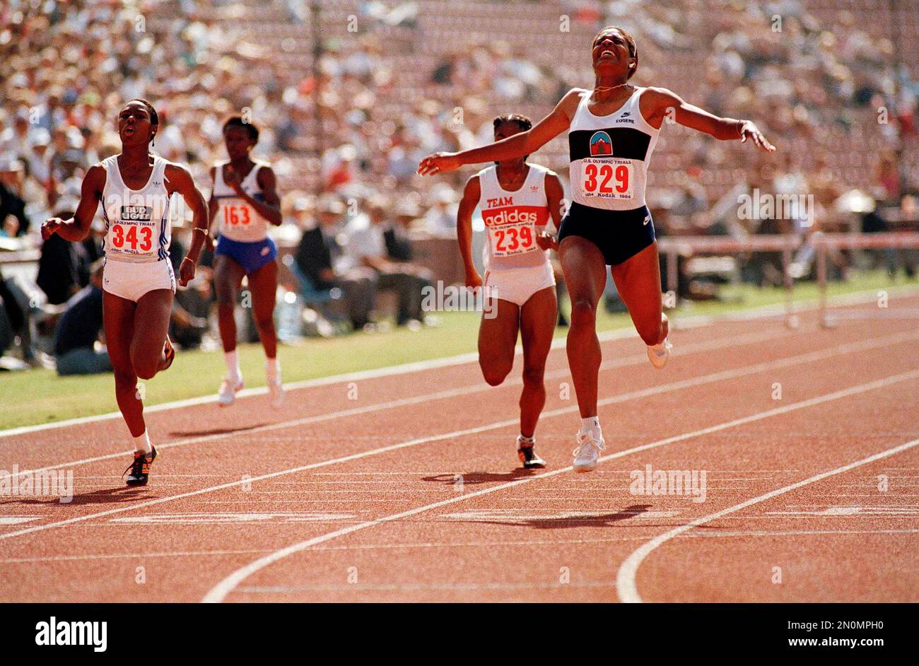Judi Brown (329) hits the wire of the women's 400-meter intermediate ...