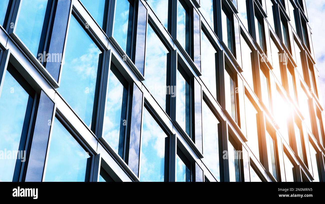 Modern office building with glass facade on a clear sky background ...