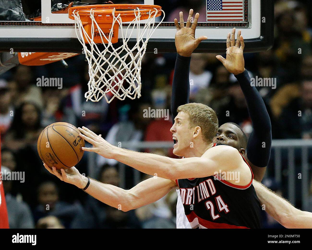 Portland Trail Blazers' Mason Plumlee, left, puts up a shot against ...