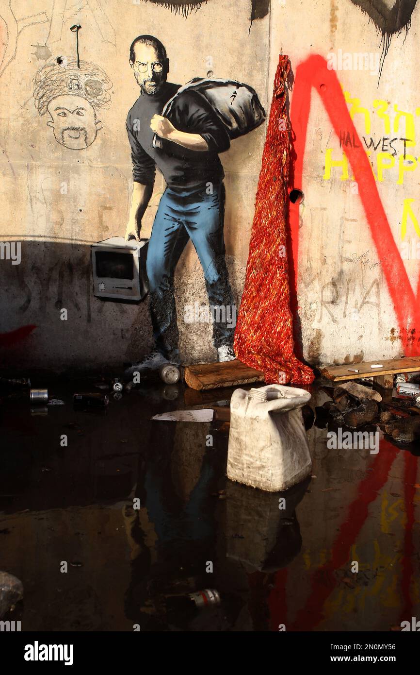 A painting by English graffiti artist Banksy is seen at the entrance of ...